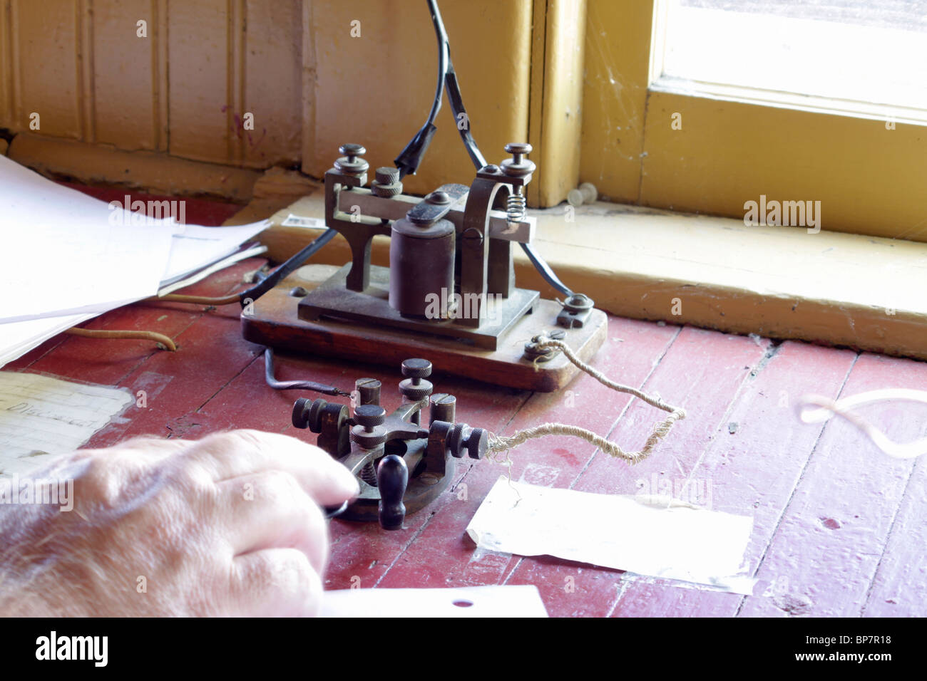 Sending morse code on a telegraph wire on equipment from about 1910 ...
