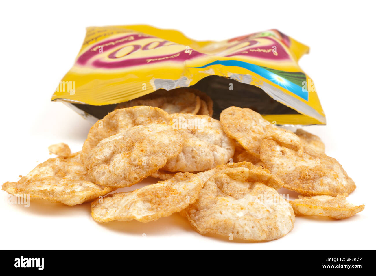 Yellow packet of potato snacks spilling onto a white surface Stock ...