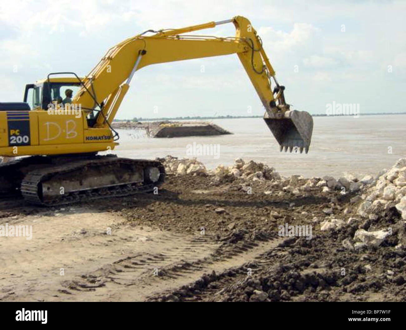 Municipal administration worker busy to repair a wide breach at Guide ...