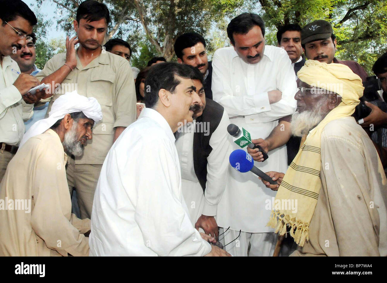 Prime Minister, Syed Yousuf Raza Gillani sits on a cart with flood ...