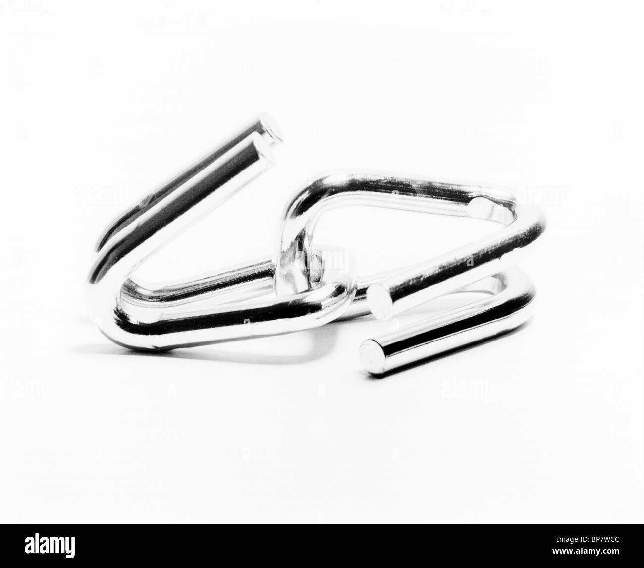 Linked metal puzzle Stock Photo - Alamy