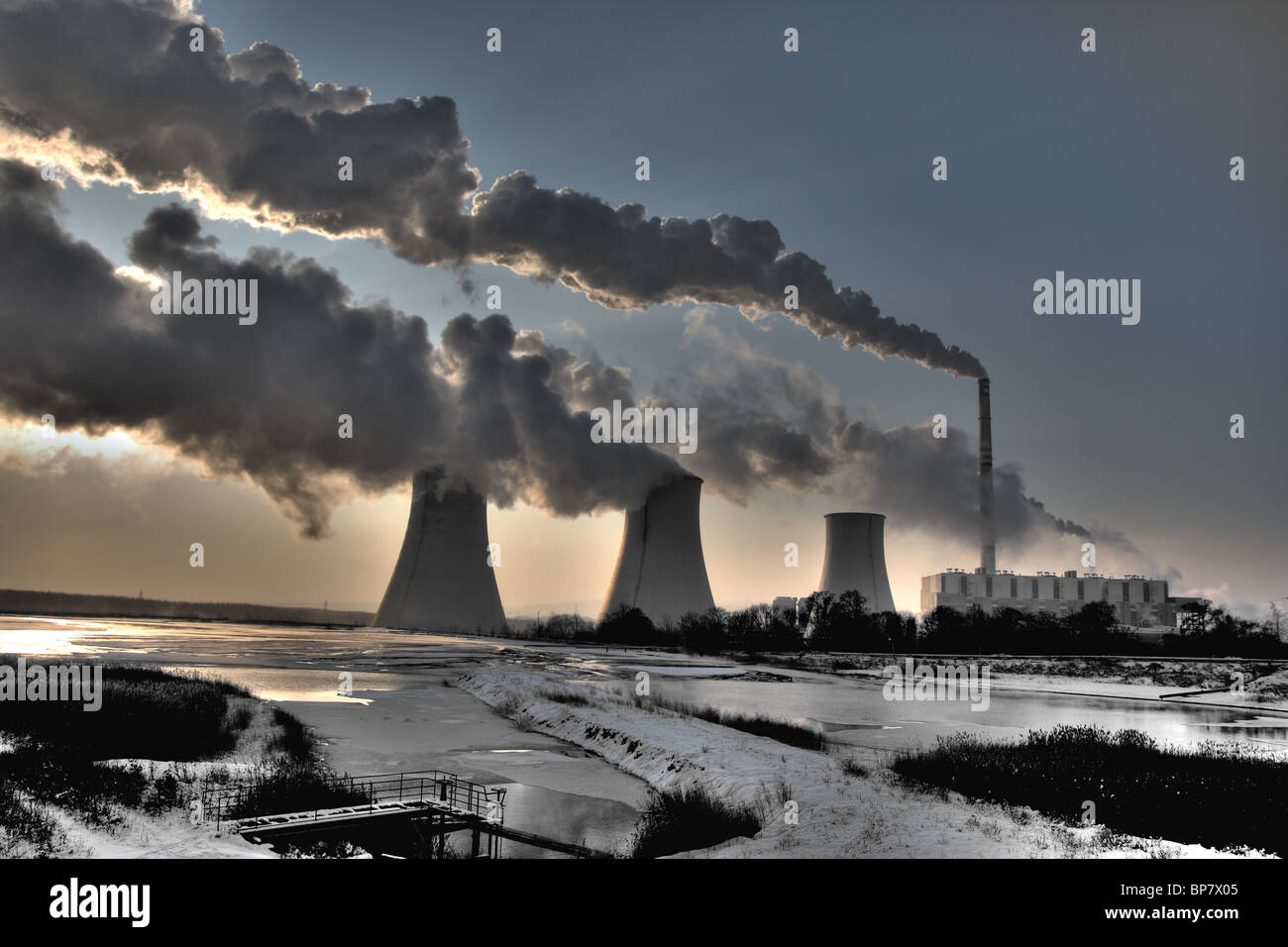 Coal powerplant against sun with several chimneys and fumes Stock Photo ...