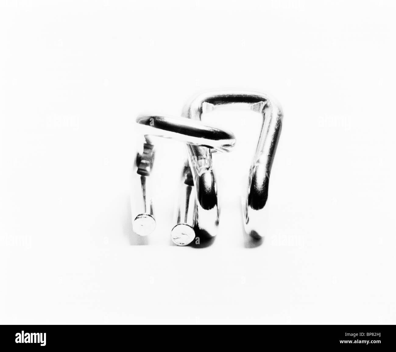 Linked metal puzzle Stock Photo - Alamy