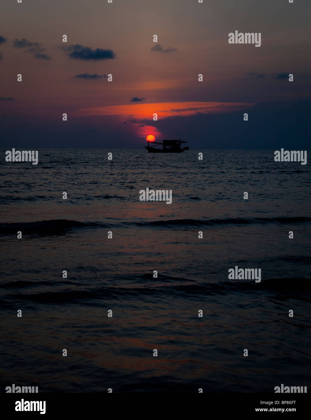 Fishing boat in sunset sky Stock Photo - Alamy