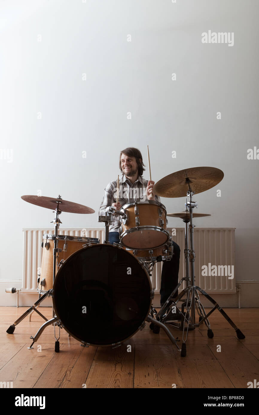 Young man plays drum set Stock Photo - Alamy