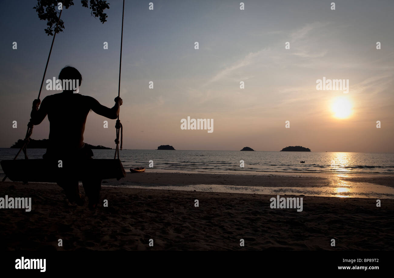 Man swings into the sunset Stock Photo - Alamy