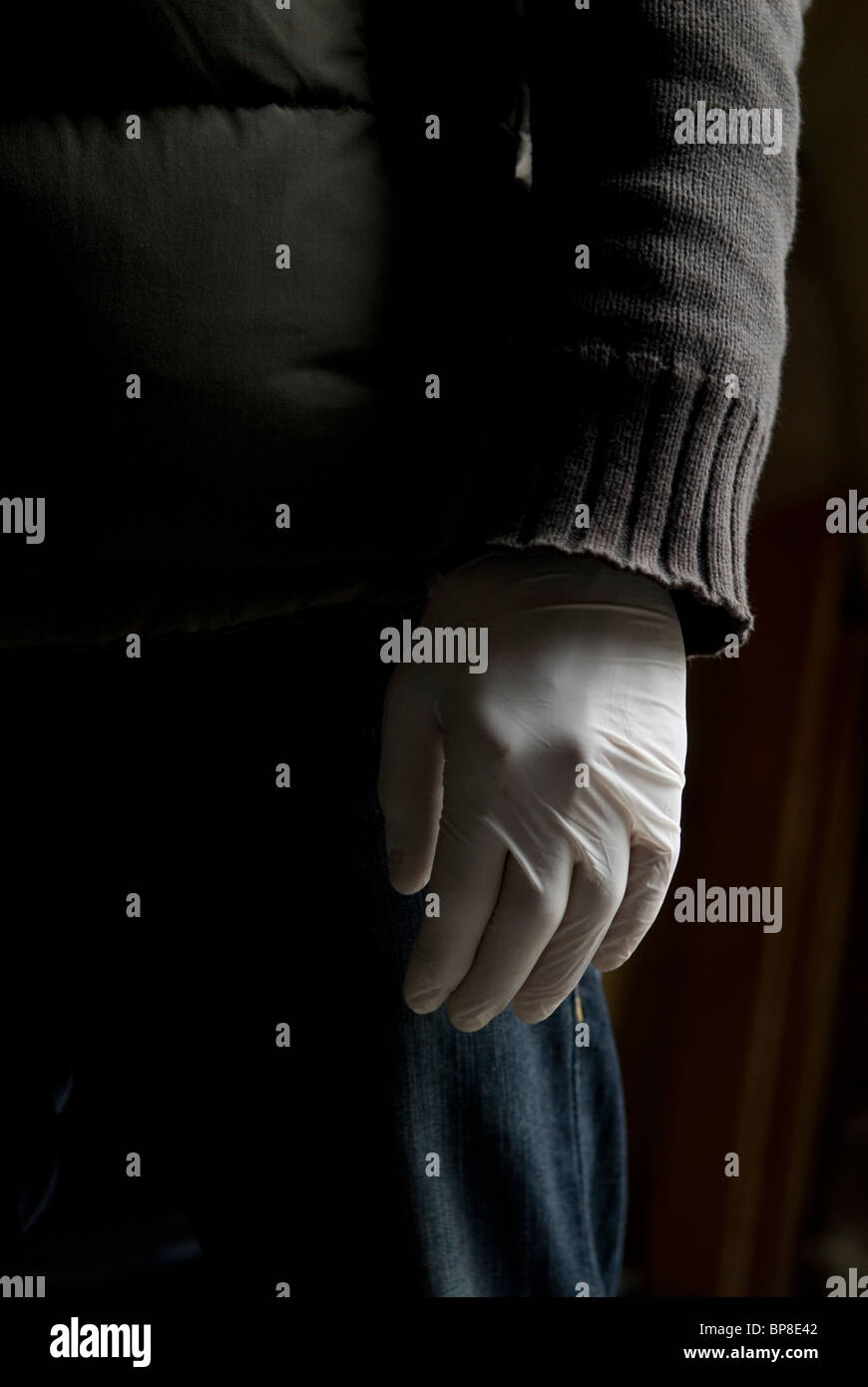 CLoseup of a burglar's hand wearing rubber gloves Stock Photo - Alamy