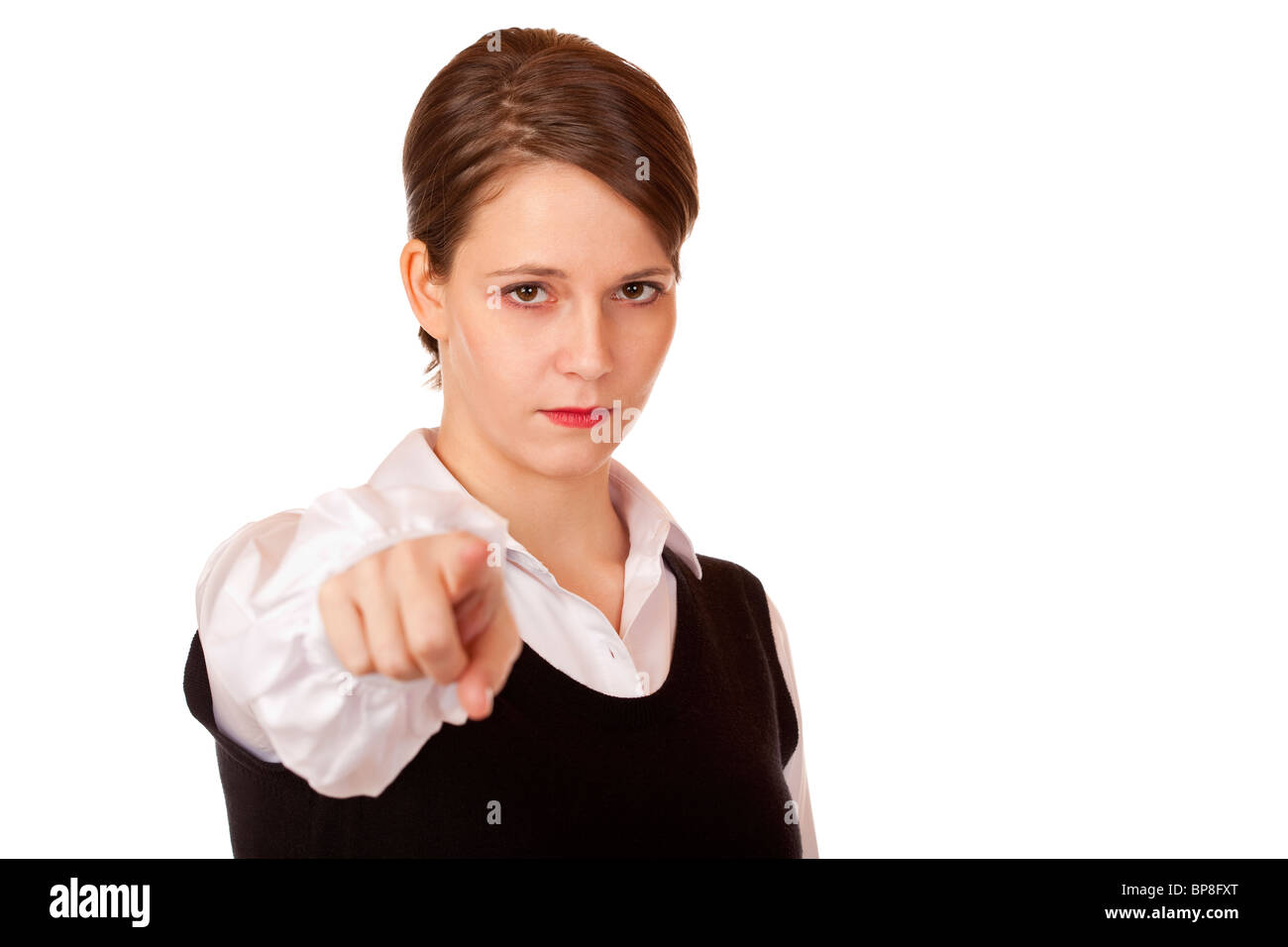 Serious looking business woman points with finger on camera. Isolated ...