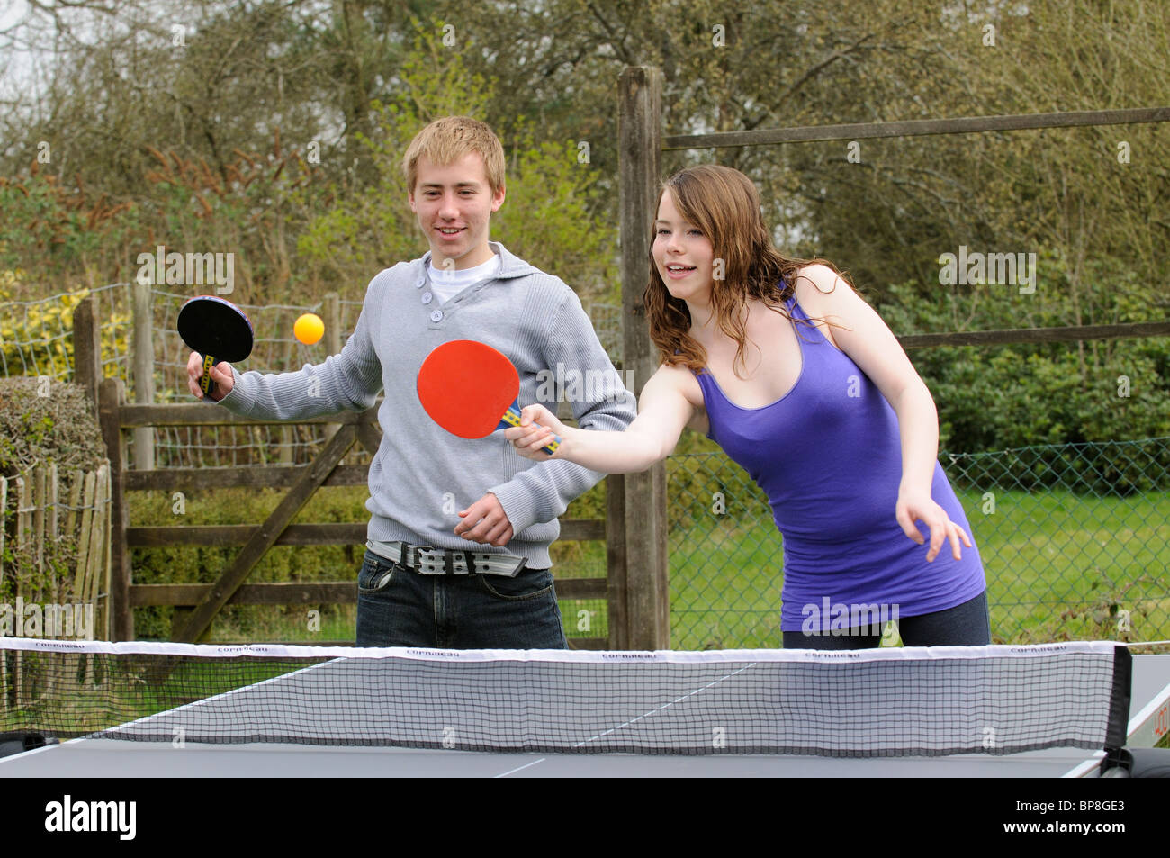 Young teenagers boy and girl playing table tennis Stock Photo - Alamy