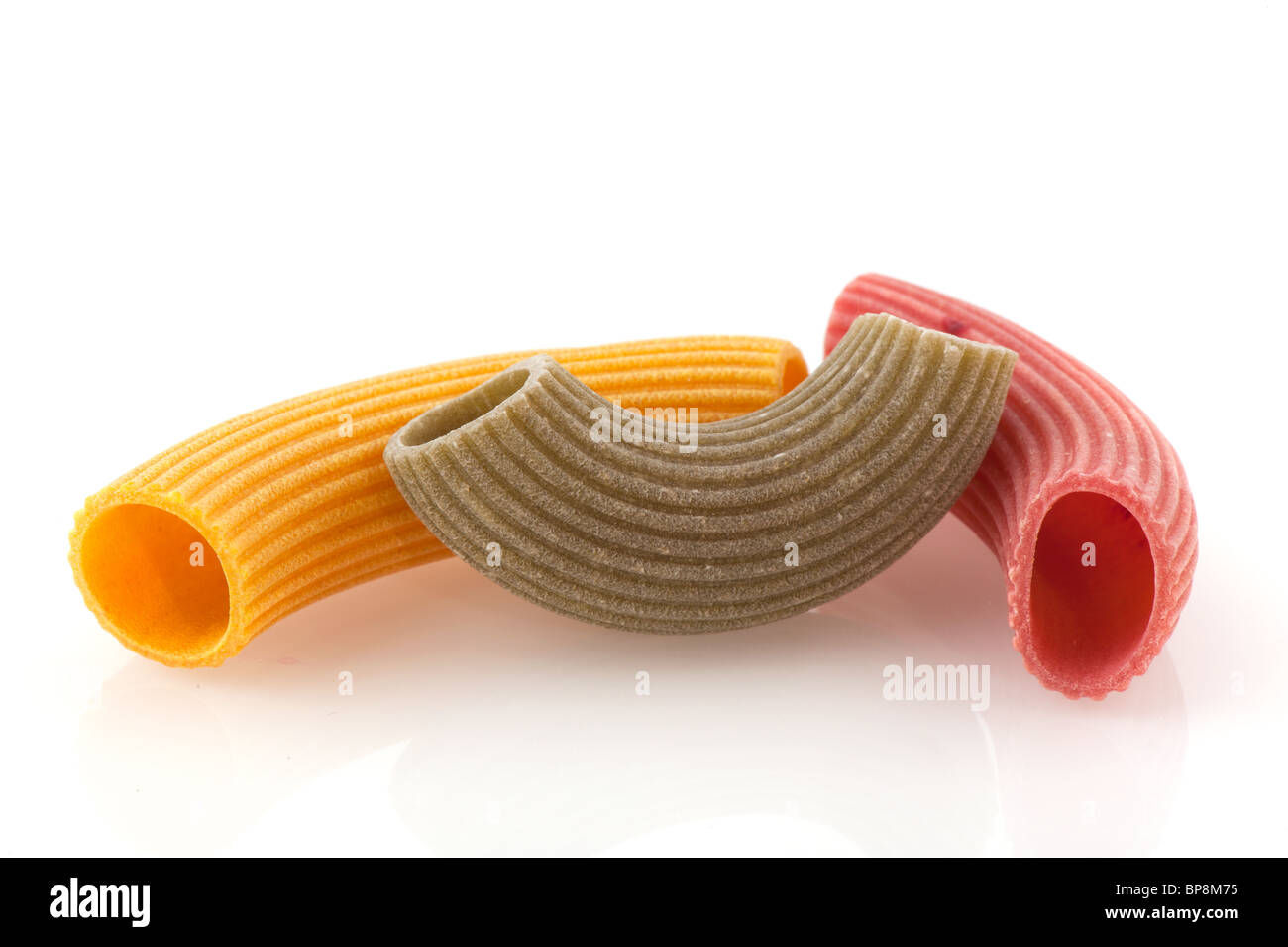 colorful raw pasta tubes in green red and white Stock Photo - Alamy