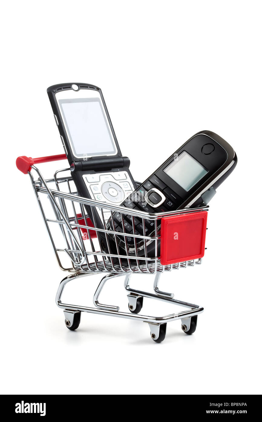 mobile phone and wireless telephone in shopping cart on white ...