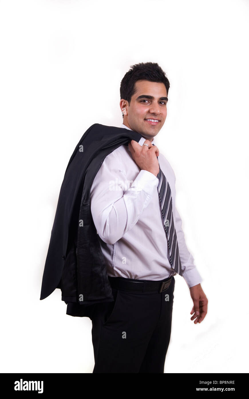 Young business man carrying his suit jacket standing against a white ...
