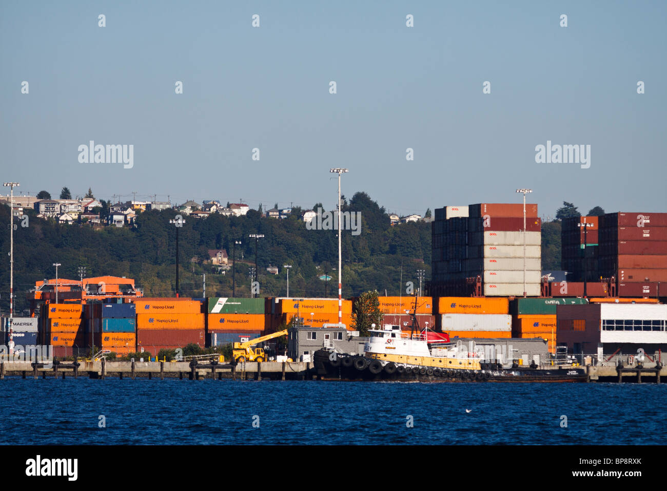 Tug boat tied up to wharf with stacks of shipping containers, Duwamish ...