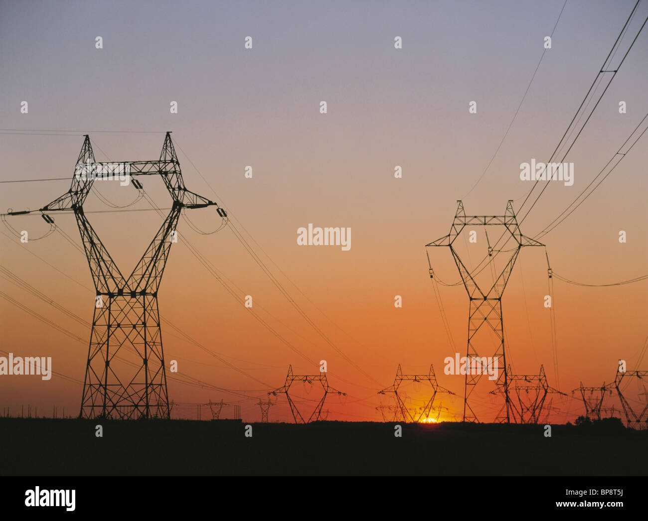 Electricity Pylons and Power Lines at Sunset Stock Photo - Alamy