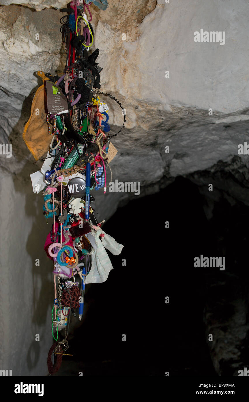 Objects left hanging by visitors to cave chapel Crete Greece Stock ...