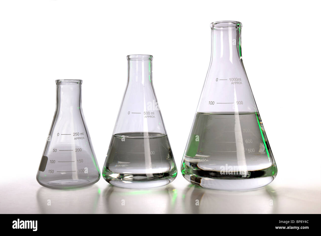 Laboratory flasks over white background with table reflections Stock ...