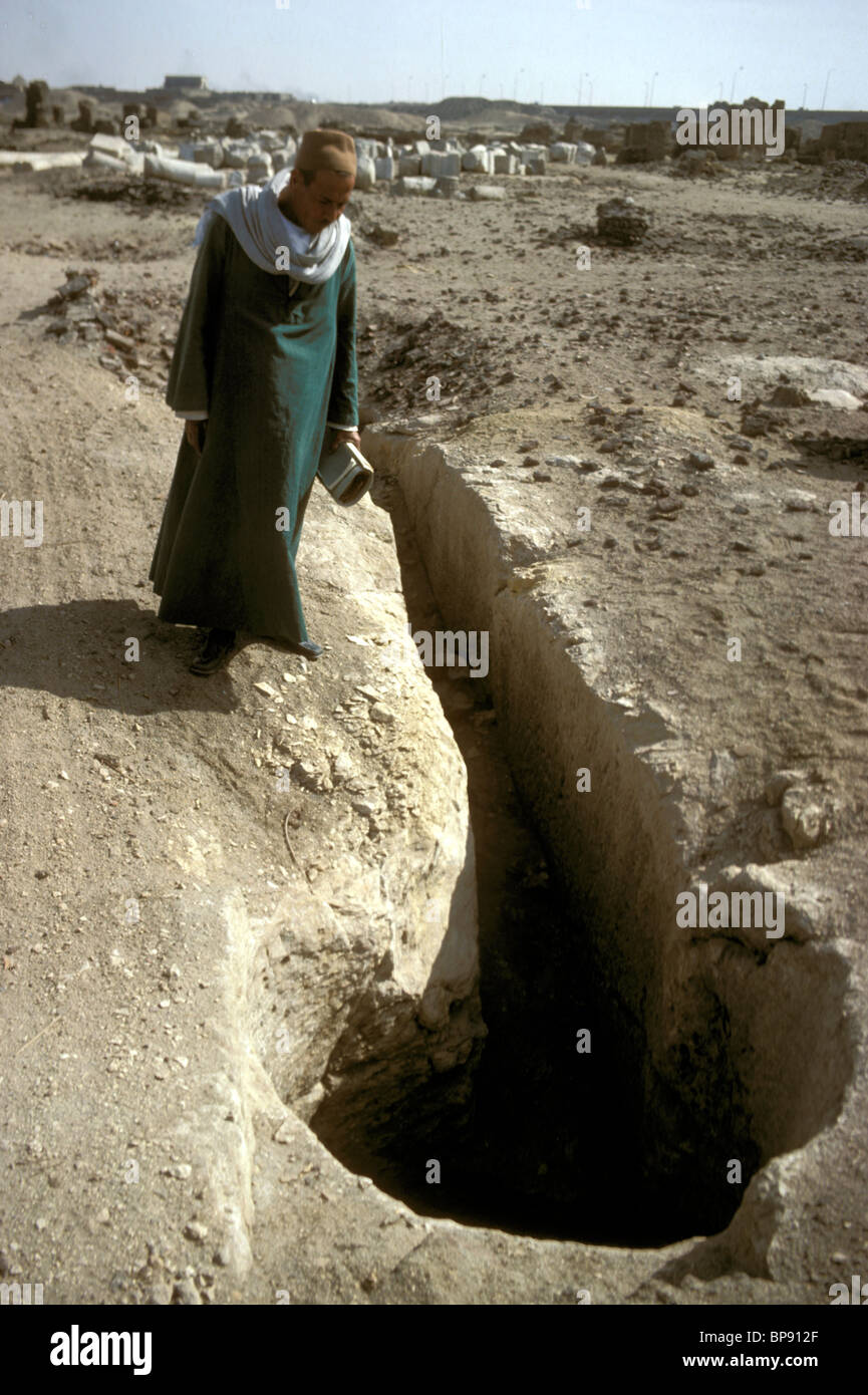 A guide looking into a trench under which is the original settlement of ...