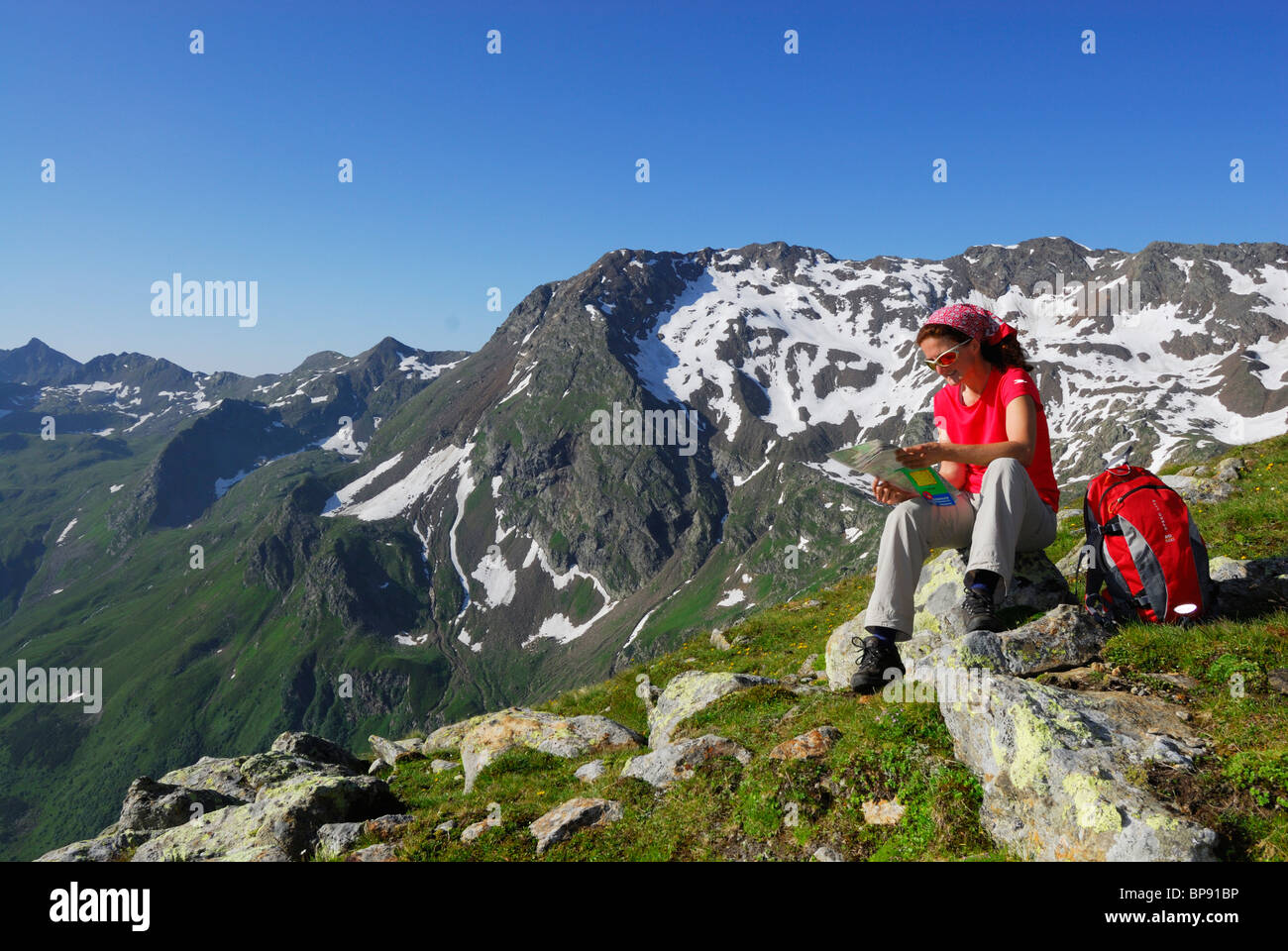 Female hiker reading map, Stubai Alps, Trentino-Alto Adige/South Tyrol ...