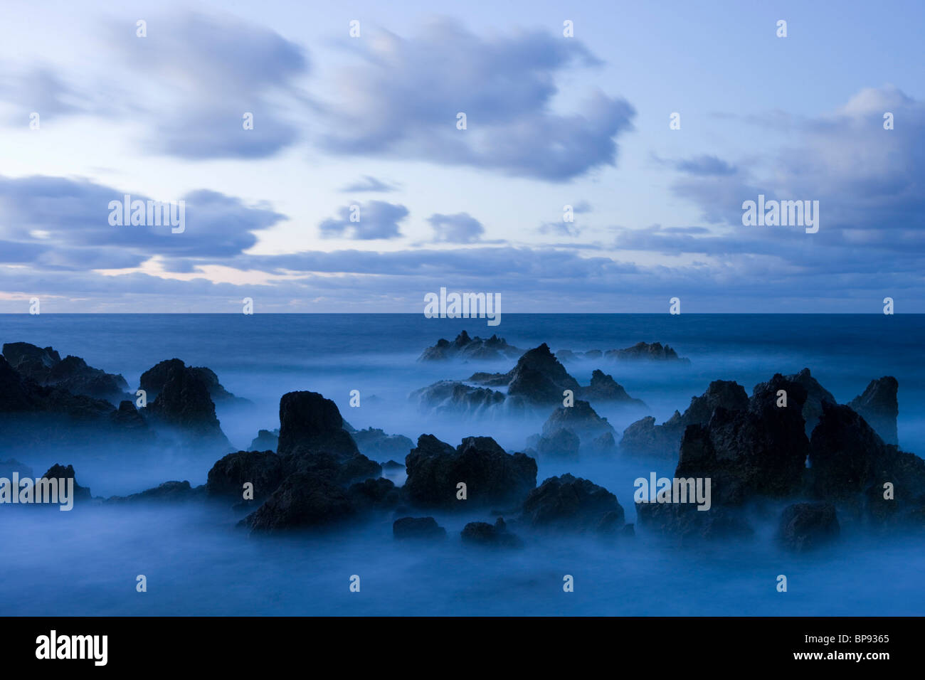 Lava rocks at dusk surrounded by sea water, Porto Moniz, Madeira ...