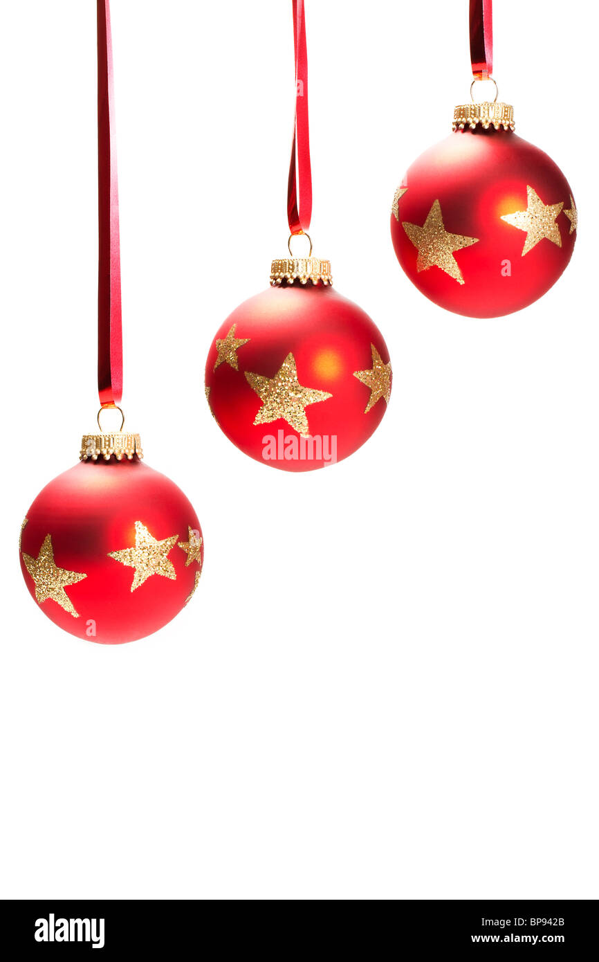 three hanging dull red Christmas balls with golden glitter stars on ...
