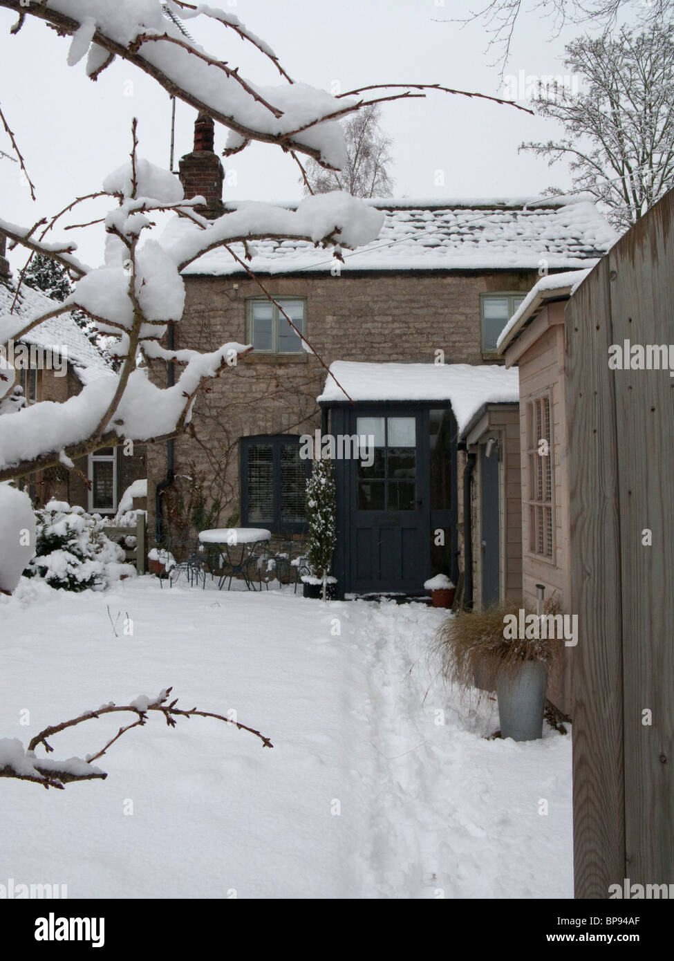 Footprints in thick snow up the garden path Stock Photo - Alamy
