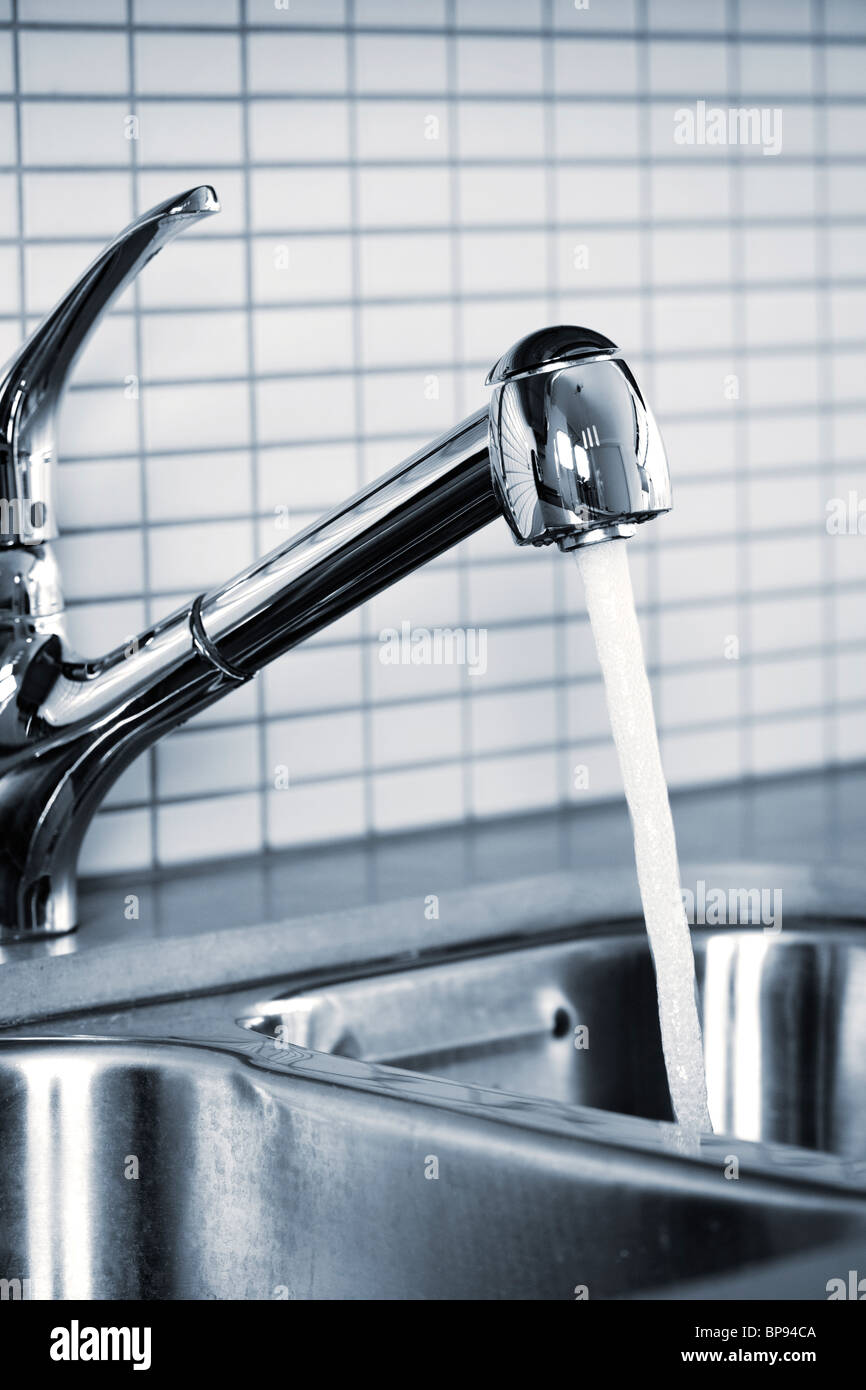 Stainless steel kitchen faucet and sink with running water Stock Photo ...