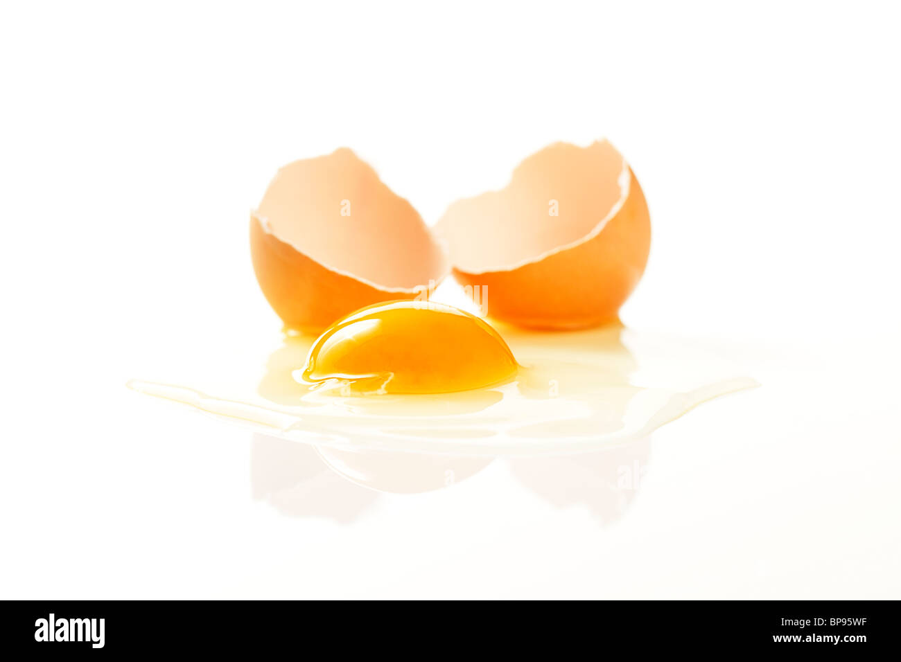 cracked egg on white background Stock Photo - Alamy