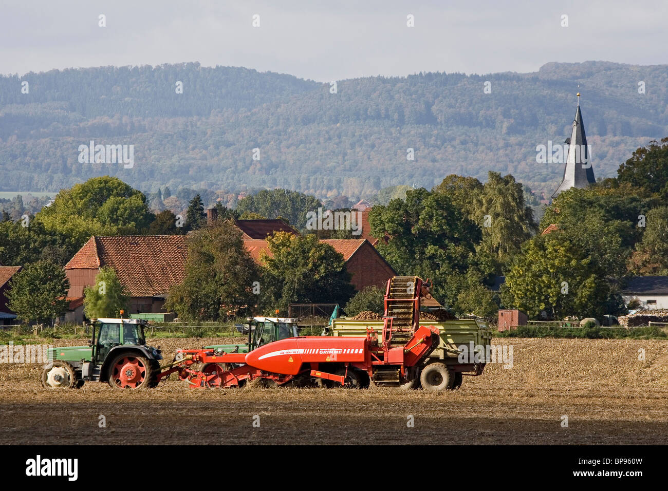 tractor working in the field, village, agriculture, rural landscape ...