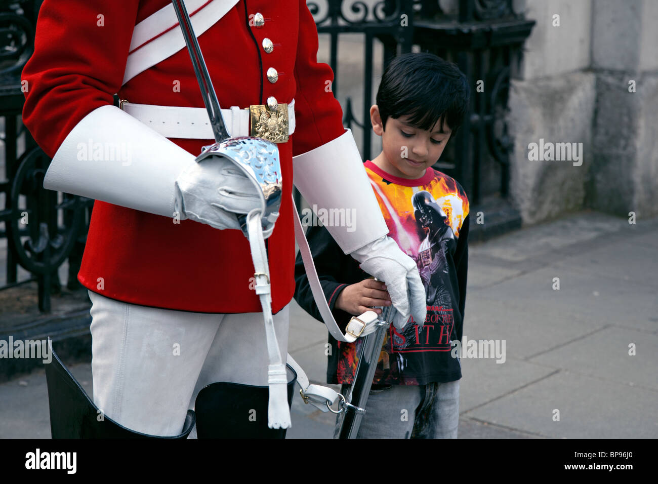 a boy and a royal guard in london Stock Photo - Alamy