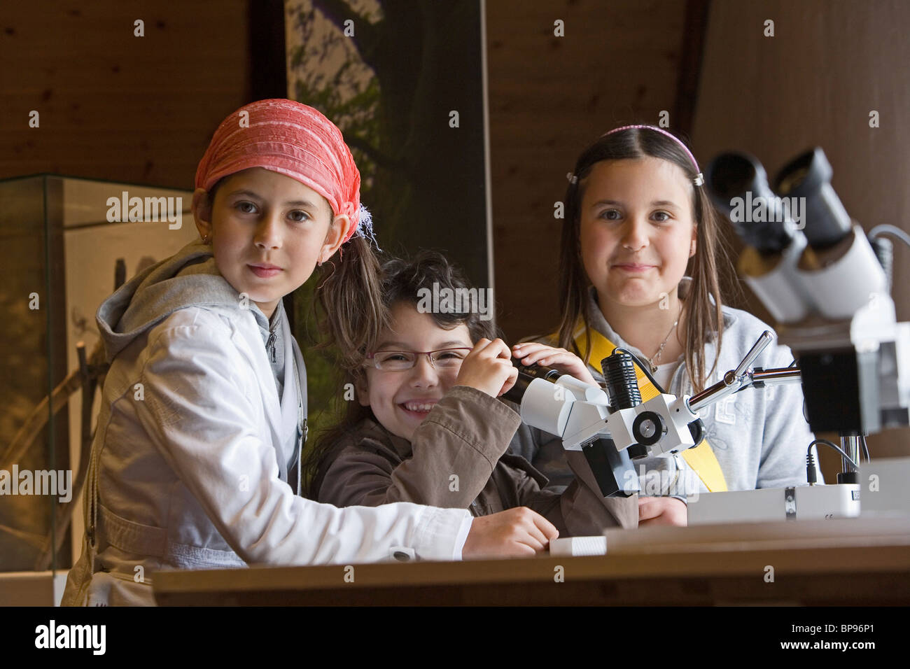 children investigate with a microscope in the Springe Museum, region ...