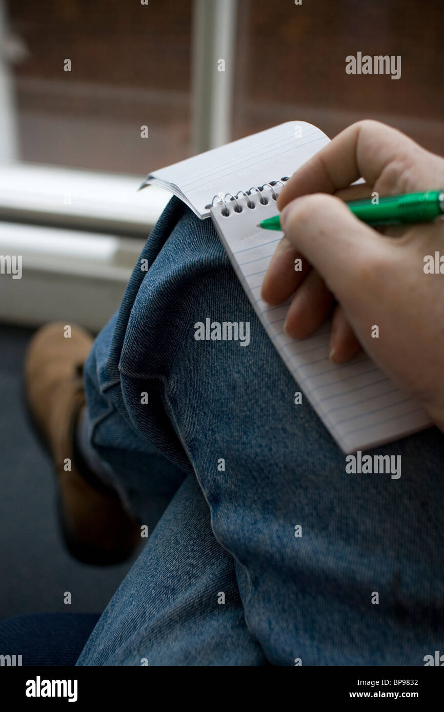 Making notes in a notebook Stock Photo - Alamy