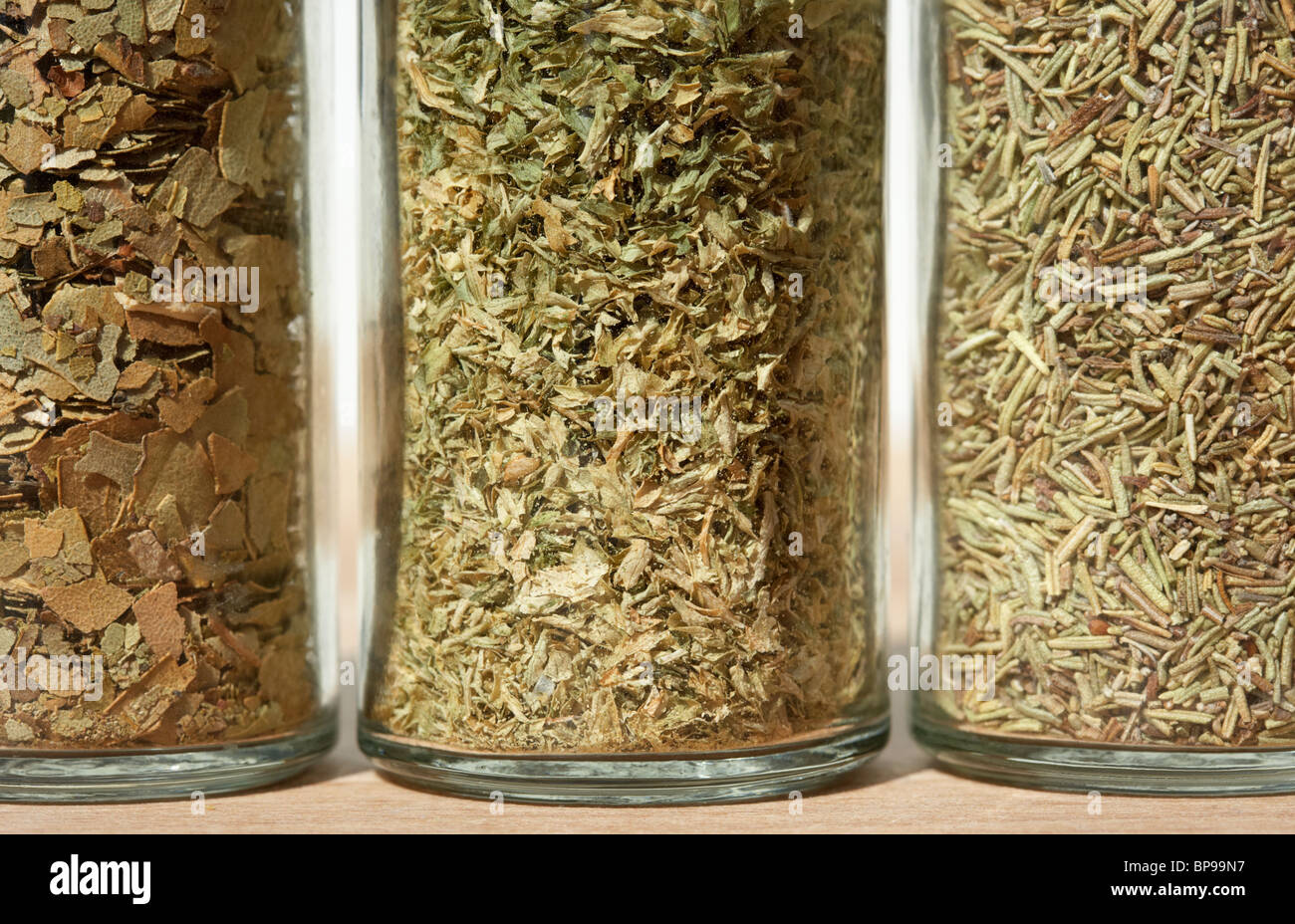 containers of different dried herbs including bay leaves parsley and ...