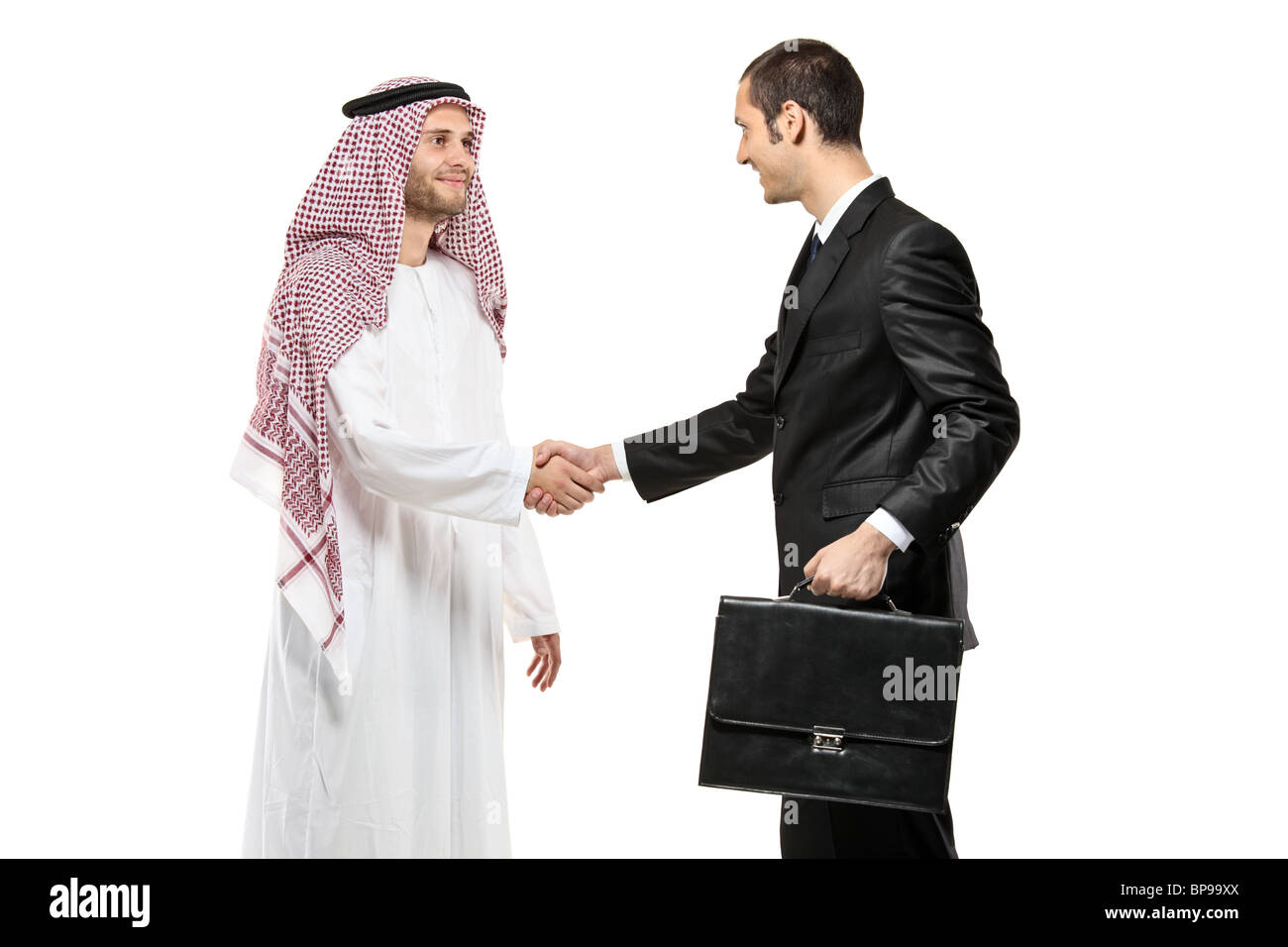 An Arab person shaking hands with a businessman Stock Photo - Alamy