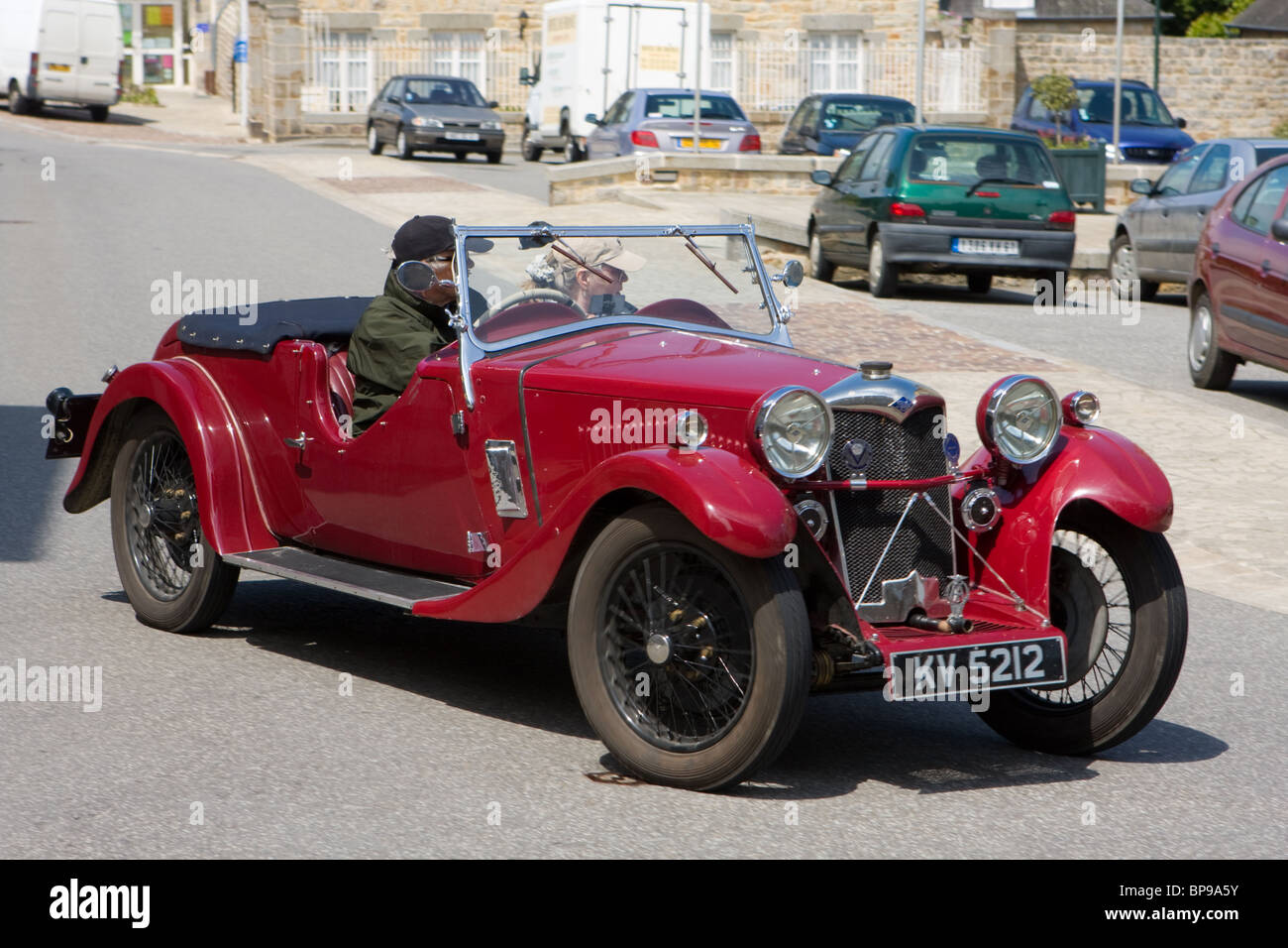 Classic British Riley Motor Car driving through the town of Domfront in ...