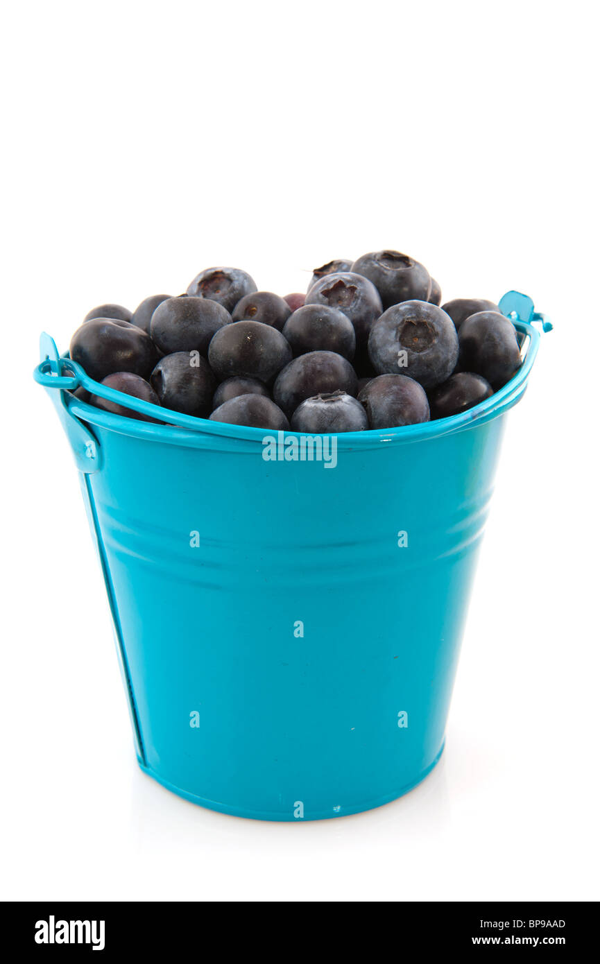 Blue bucket with blueberries isolated over white Stock Photo - Alamy