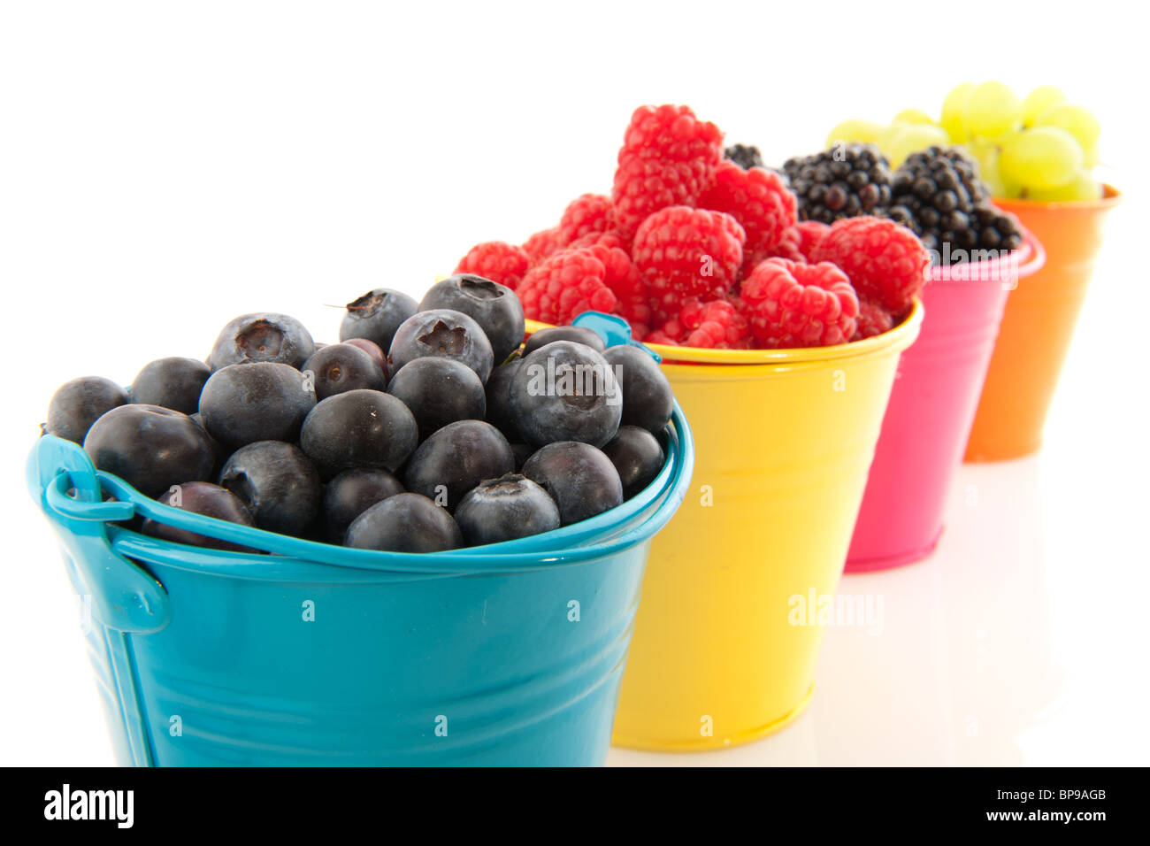 Colorful buckets with fresh fruit isolated over white Stock Photo - Alamy