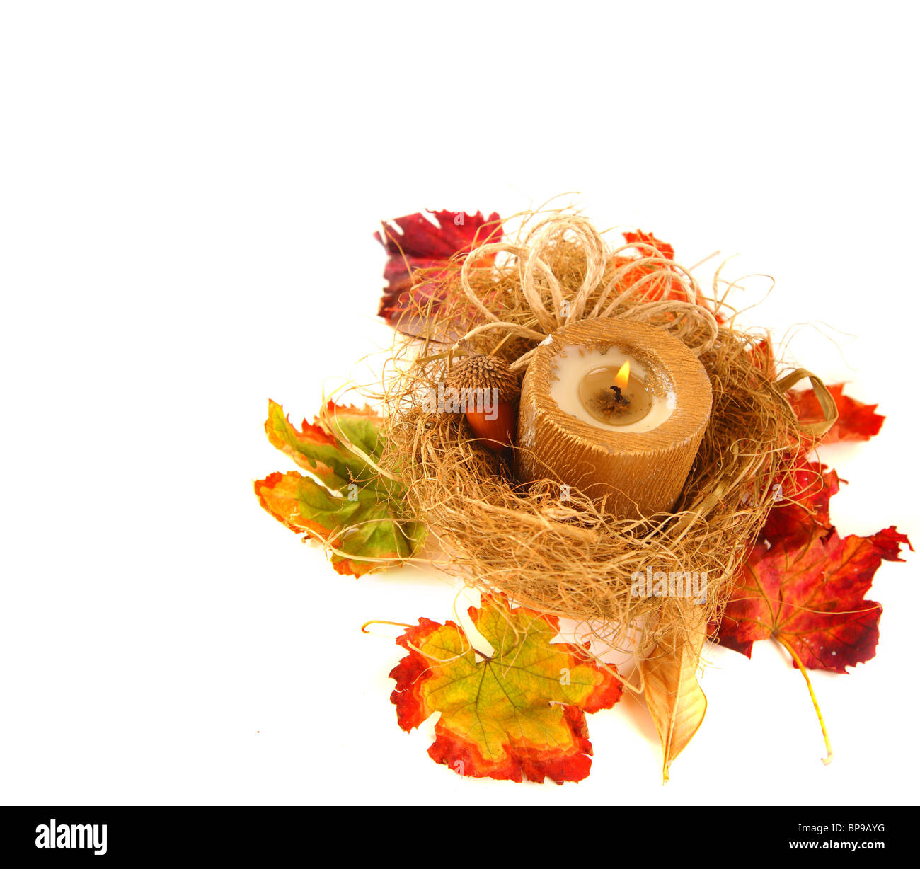 Yellow candle on the autumn leaves Cut Out Stock Images & Pictures - Alamy