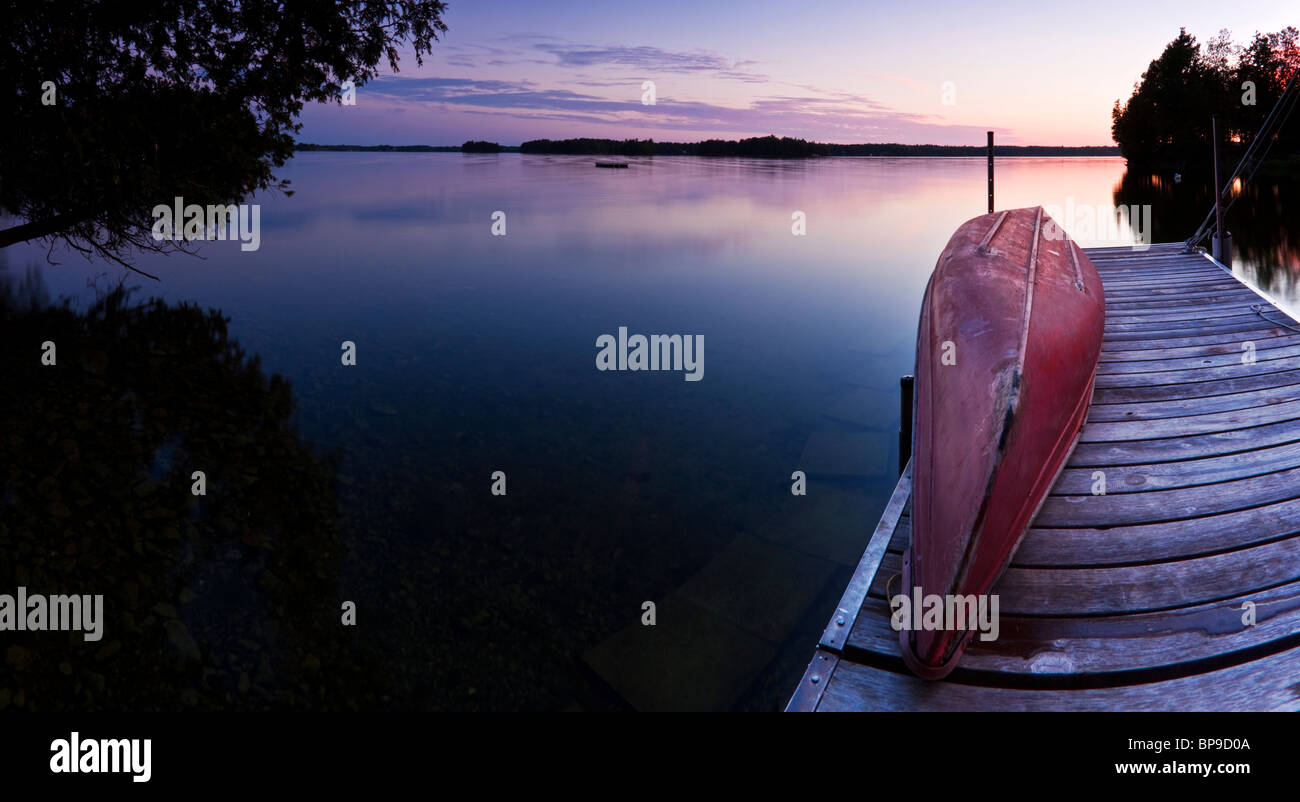 evening by a lake with a canoe Stock Photo - Alamy