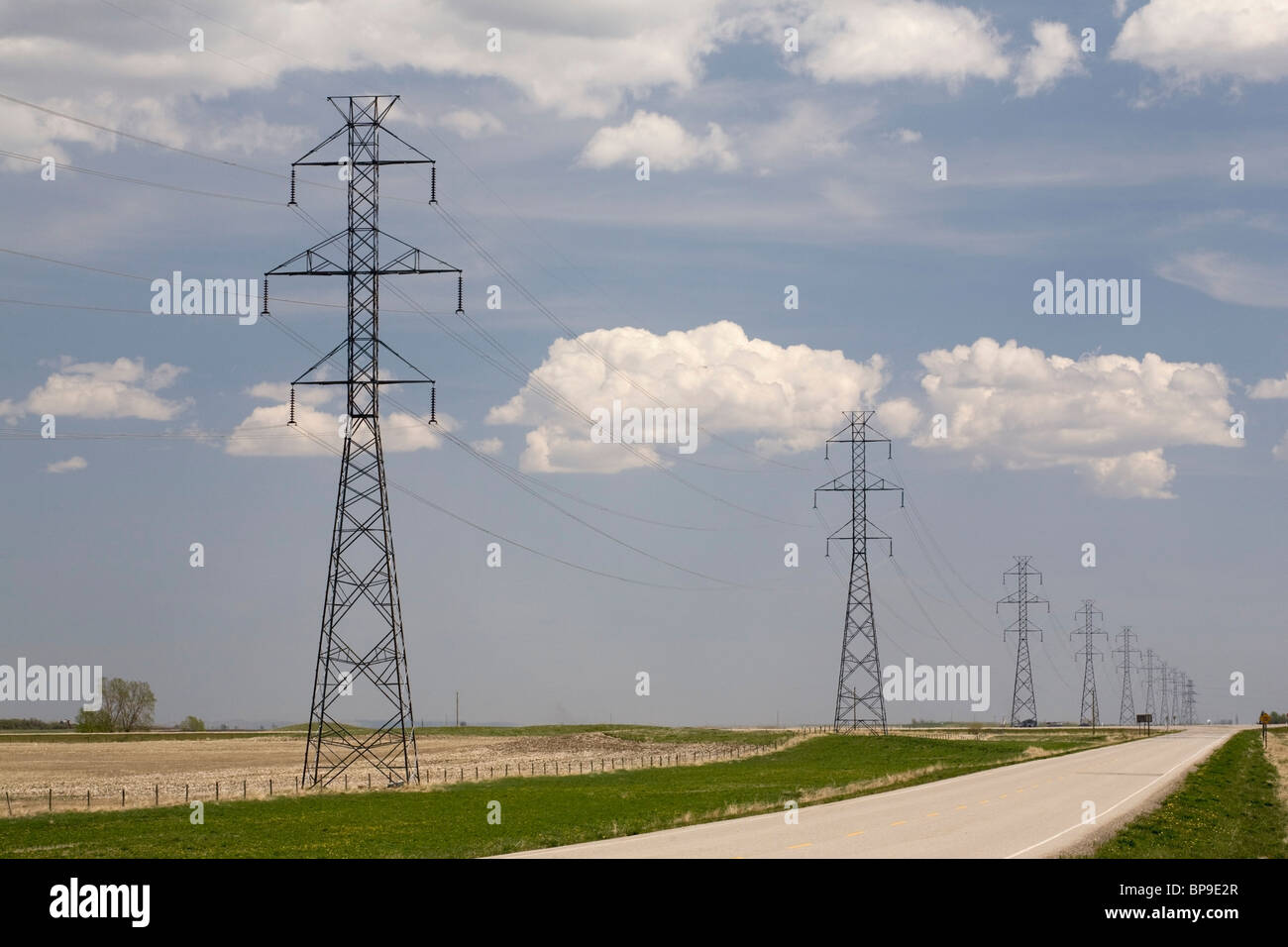 calgary, alberta, canada; metal power lines in a row running along a ...