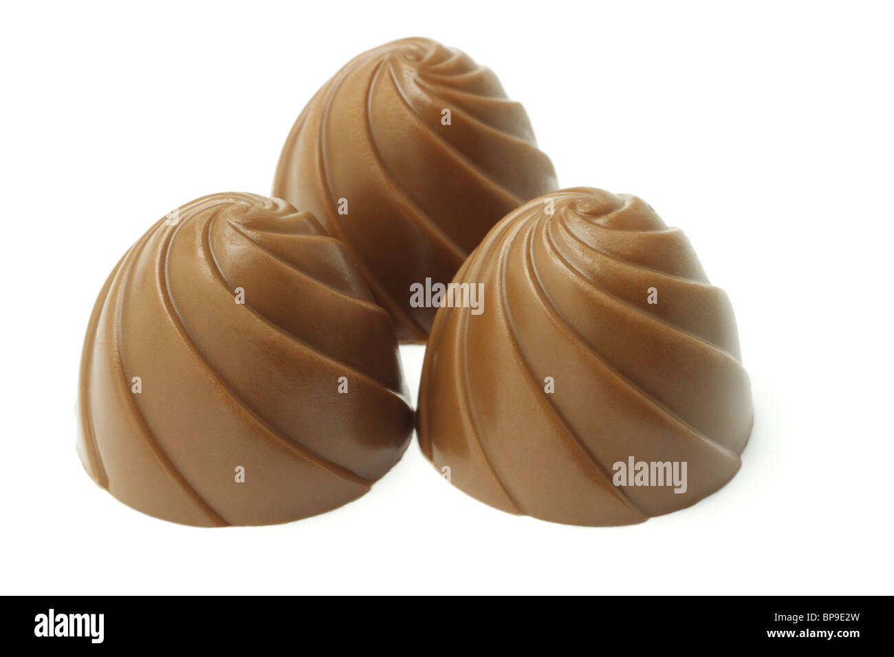 Three chocolate candies isolated on white background Stock Photo - Alamy