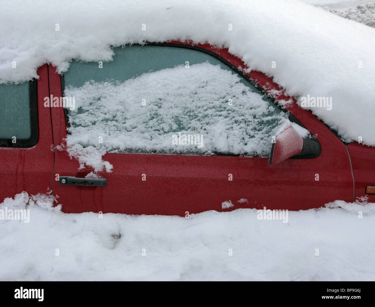 A red car, almost covered by snow Stock Photo - Alamy