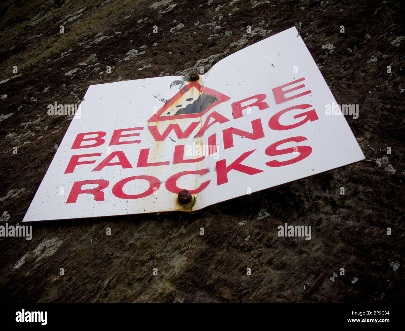 Warning sign for falling rocks on the coastal path at Ilfracombe in ...
