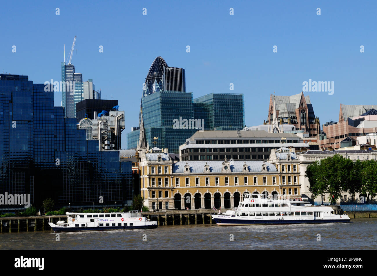 River Thames Cruise boats and city of London buildings, London, England ...