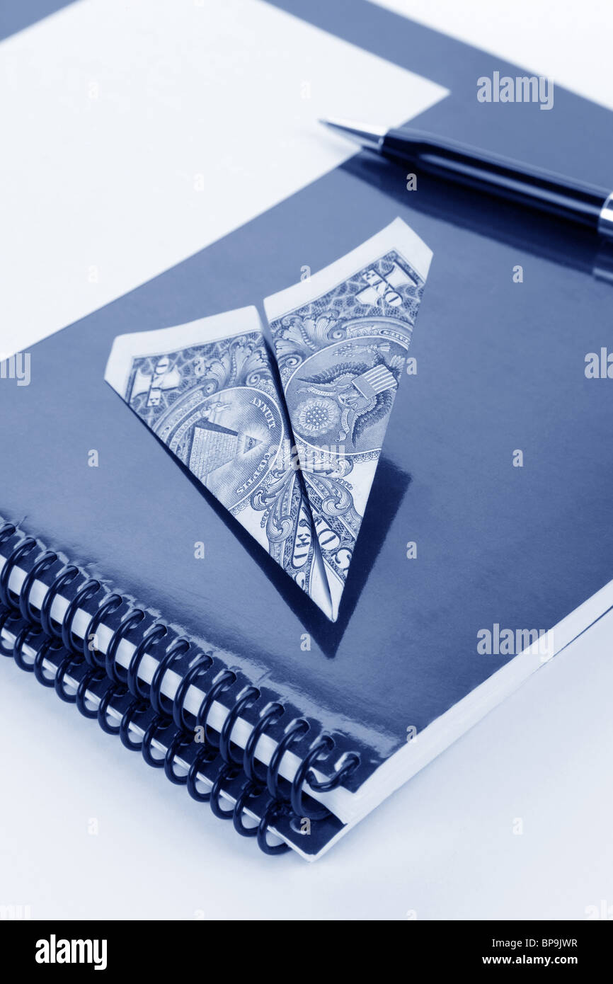 Blue school textbook, notebook or manual and dollar Stock Photo - Alamy