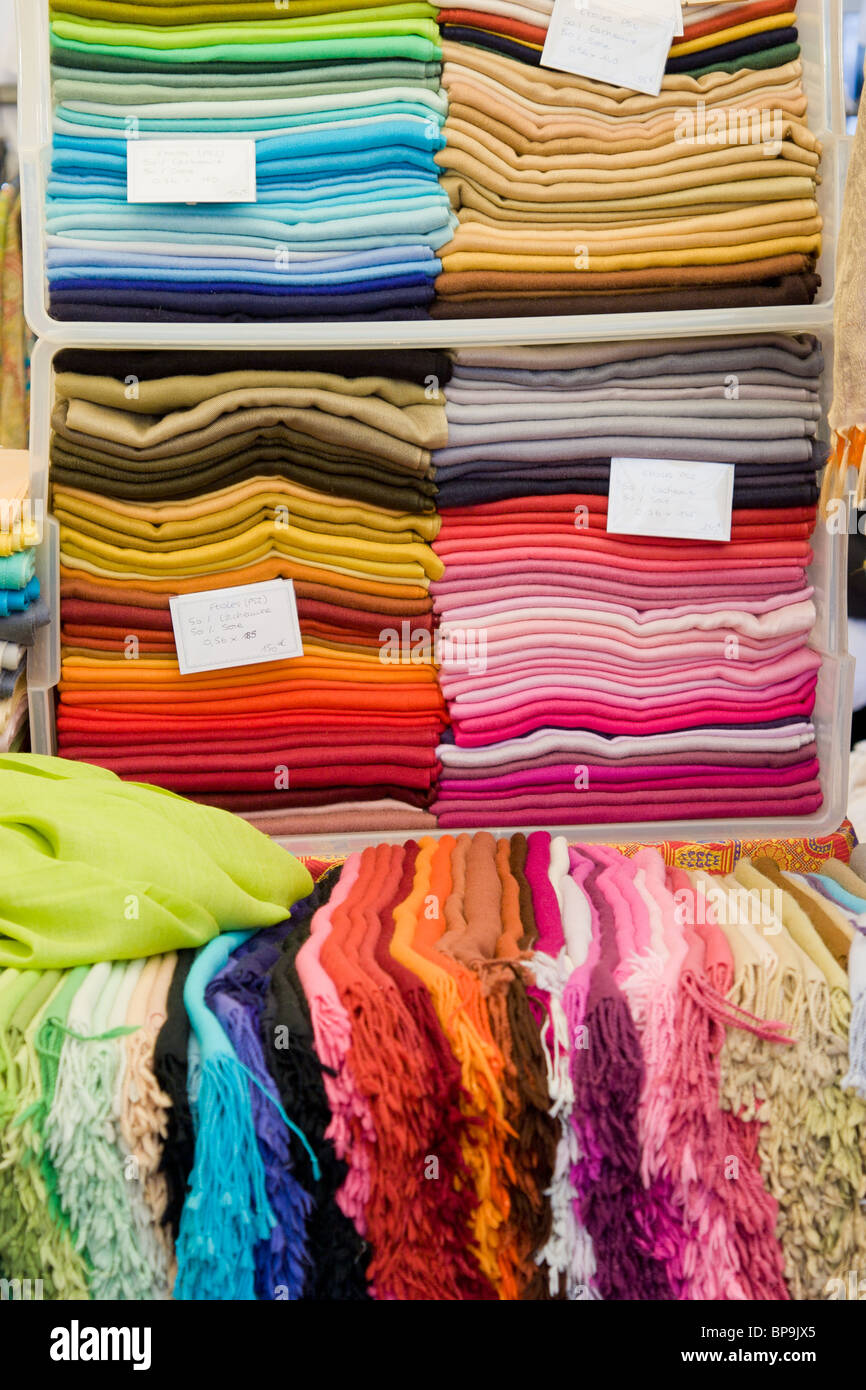 Piles of very colourful folded pieces of textile Stock Photo - Alamy