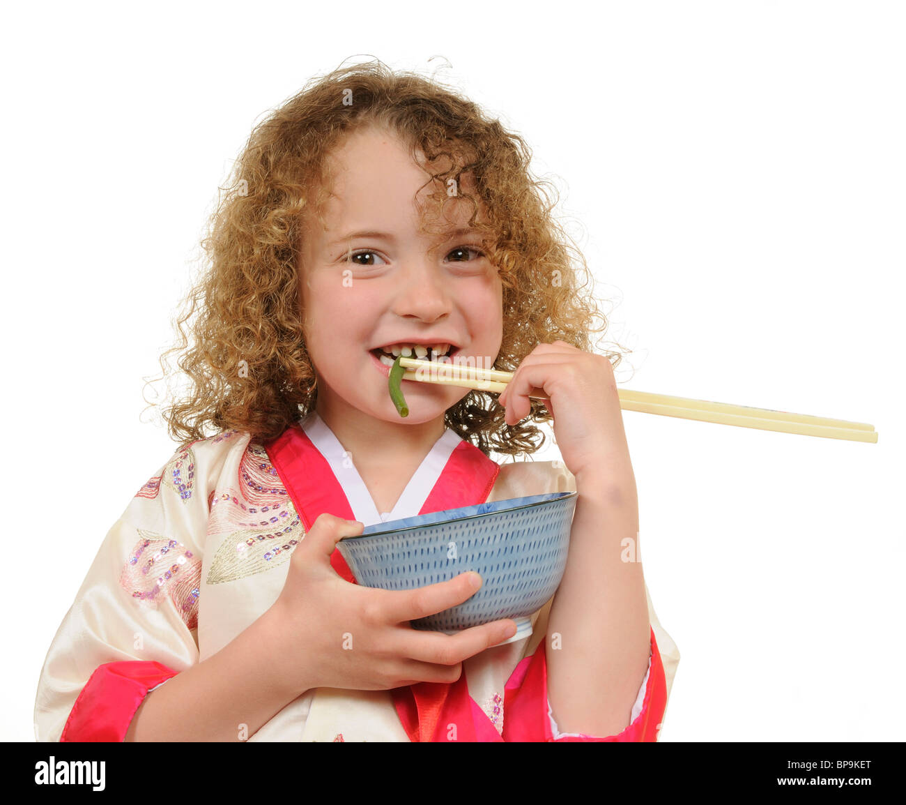 Girl child eating with chopsticks hi-res stock photography and images ...