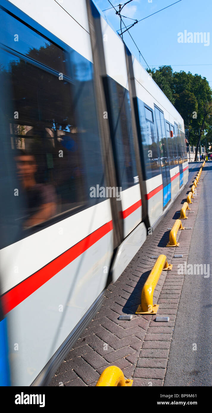Overland metro electric metro train travelling down a street with ...