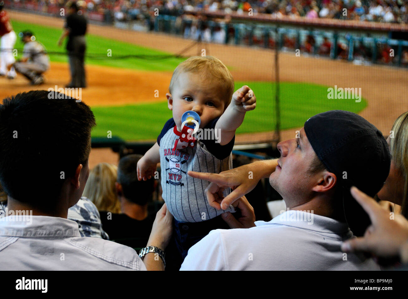 A young boy and father enjoy baseball game. Houston, Texas, USA Stock ...