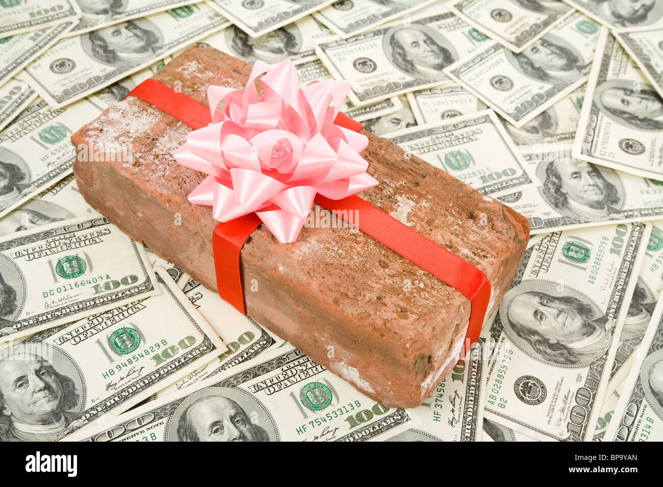 Red Brick Gift and dollars, Concept of joke, make fun of somebody, gift ...