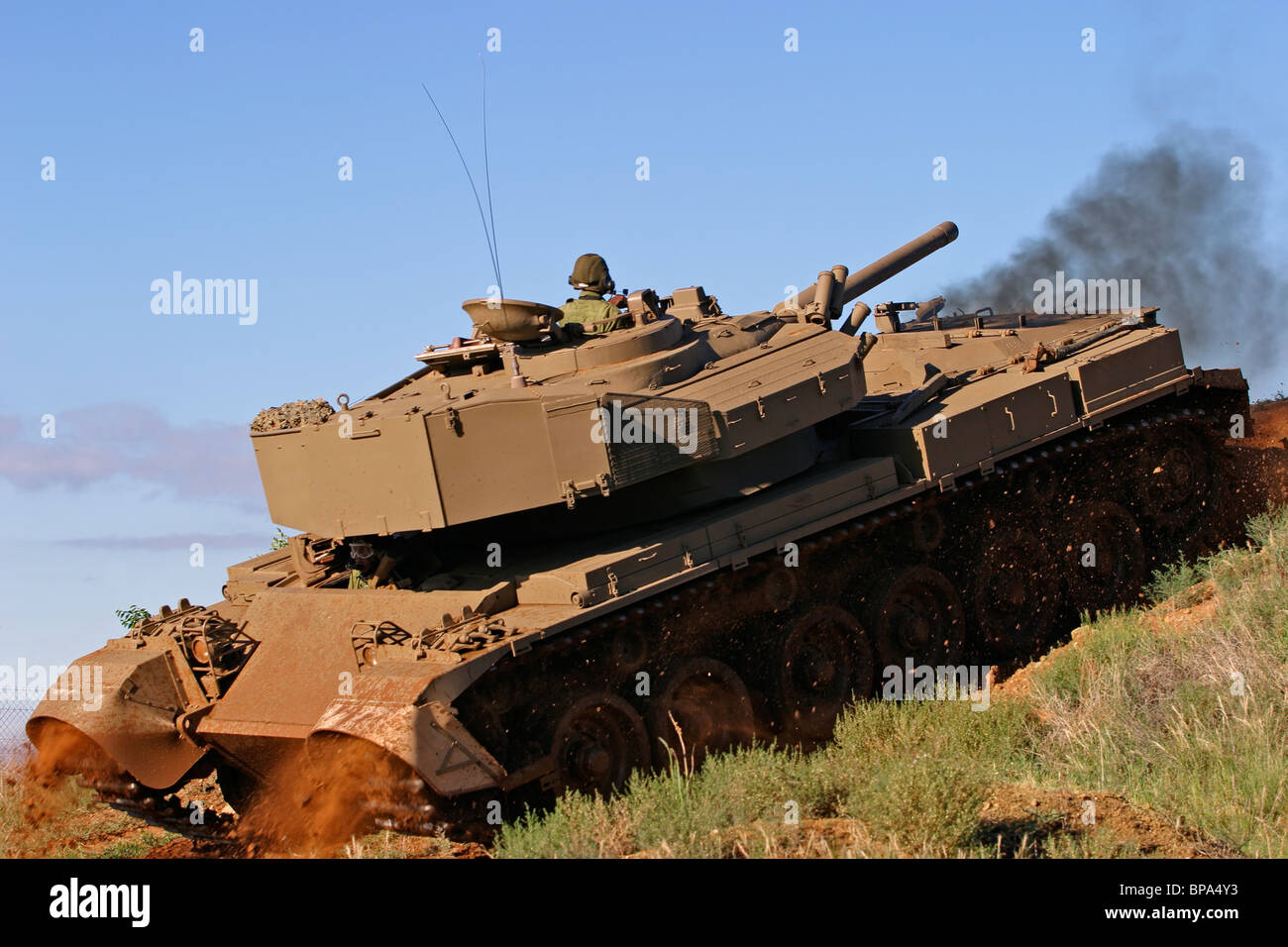 A military tank in action over rough terrain Stock Photo - Alamy